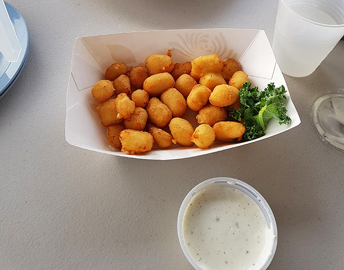 Golden-fried cheese curds that would make any Wisconsin grandmother proud – crispy exterior giving way to that perfect molten cheese pull that defines Midwestern happiness.