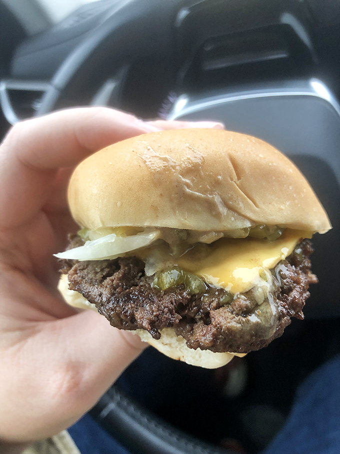 Behold the Crabill's cheeseburger in its natural habitat—your hand! That melted American cheese creates the perfect bond between beef and bun.