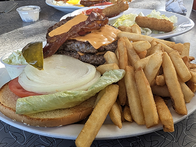 The burger that ate Hollywood. A towering masterpiece of beef, cheese, and bacon that requires both hands, napkins, and possibly a nap afterward.