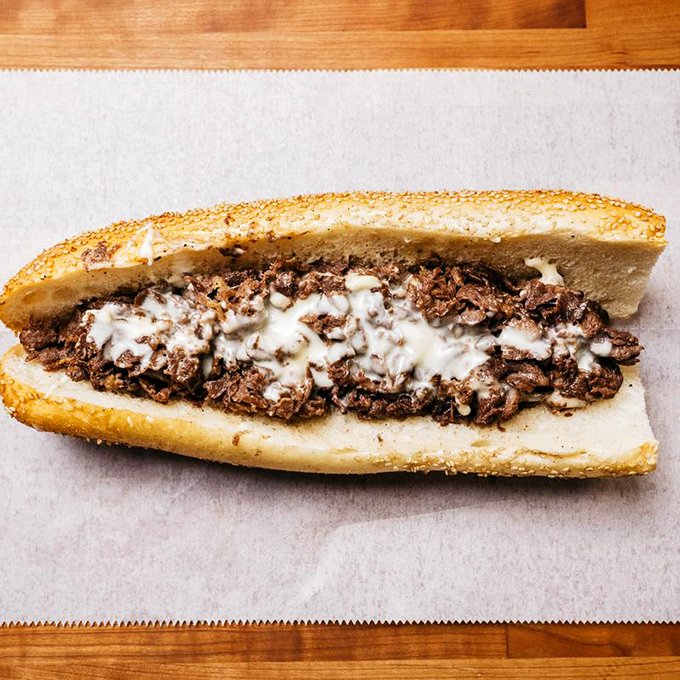 The classic cheesesteak gets the Ochinilis treatment – perfectly melted cheese cascading over tender, seasoned beef perfection.