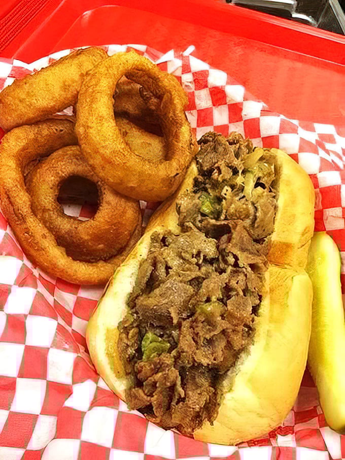 This isn't just a sandwich—it's a masterpiece of meat and melted cheese escorted by golden onion rings that deserve their own standing ovation.