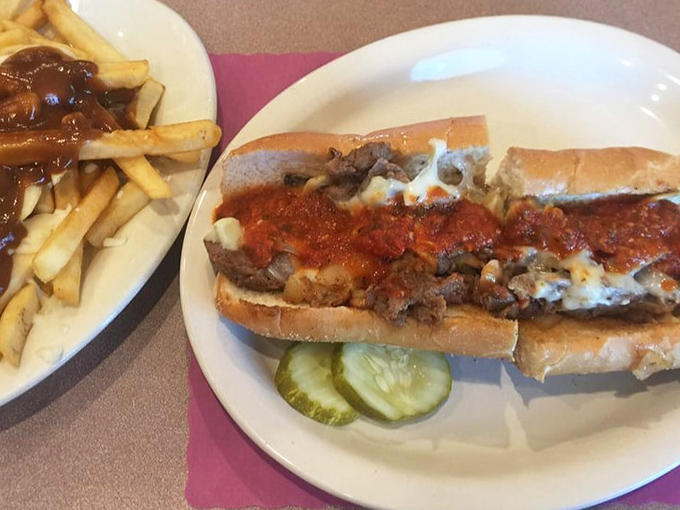 This isn't just a cheesesteak; it's edible Pennsylvania heritage on a roll, complete with those pickle slices that somehow make everything better.