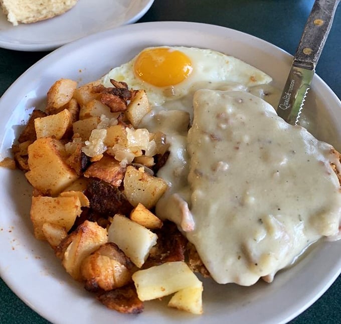 Country gravy isn't just a condiment, it's a lifestyle choice. This chicken fried steak with potatoes could fuel a cattle drive or your afternoon nap.