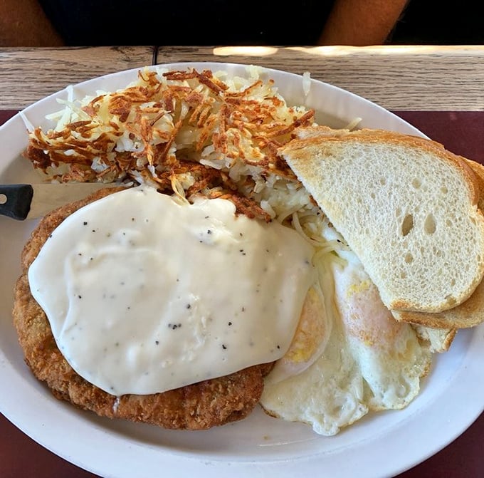 Chicken fried steak with country gravy – the breakfast equivalent of a warm hug from someone who genuinely wants you to have a good day.