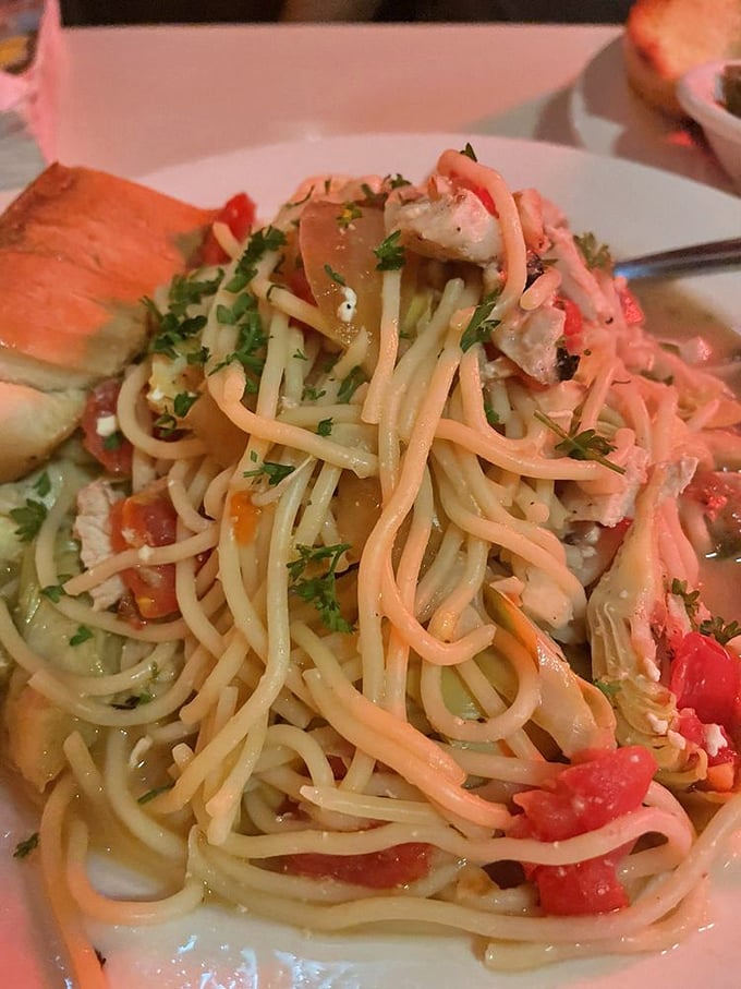 Pasta perfection that would make an Italian grandmother weep with joy—tender noodles swimming in a light sauce with chunks of chicken and fresh herbs.