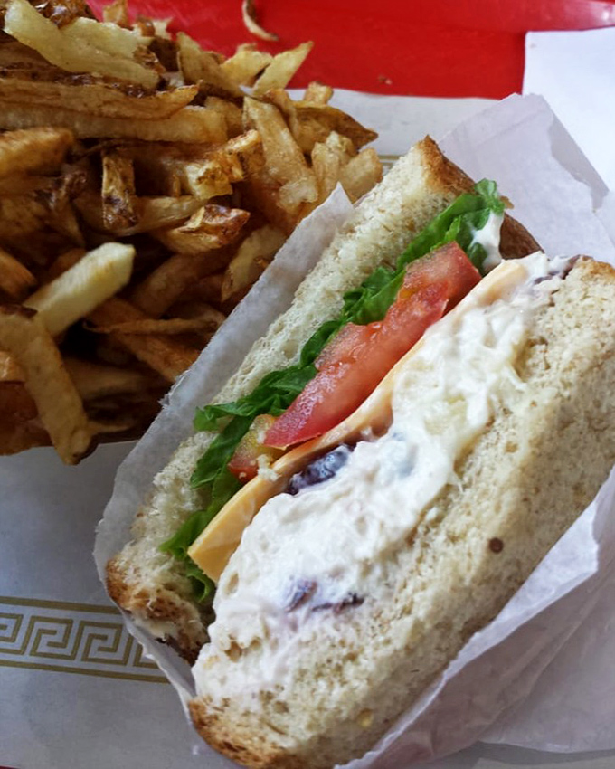 A classic sandwich paired with golden fries—comfort food that speaks the universal language of "you're going to need extra napkins."