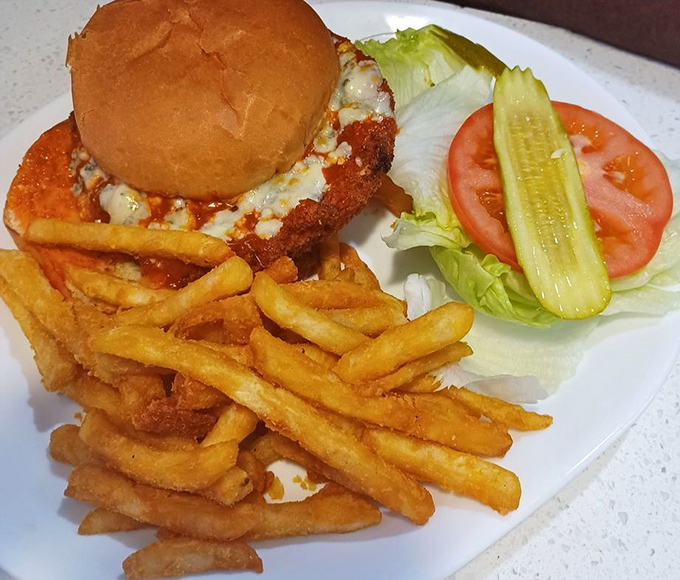 This isn't just a chicken sandwich—it's architecture. The golden-fried chicken, melty cheese, and crispy fries create the Taj Mahal of lunch options.