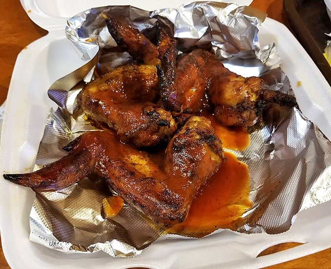 These wings aren't trying to fly—they've found their destiny in Sweet Lucy's smoker, emerging with a glaze that glistens like edible amber.