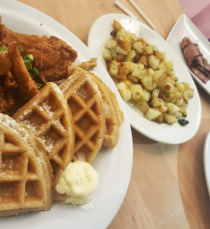 Chicken and waffles meet crispy potatoes in a harmony that would make your grandmother proud of this comfort food symphony.