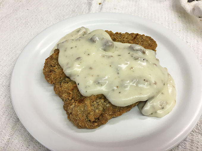 Country-fried perfection smothered in creamy gravy transforms humble steak into a breakfast worthy of Sunday morning celebrations.