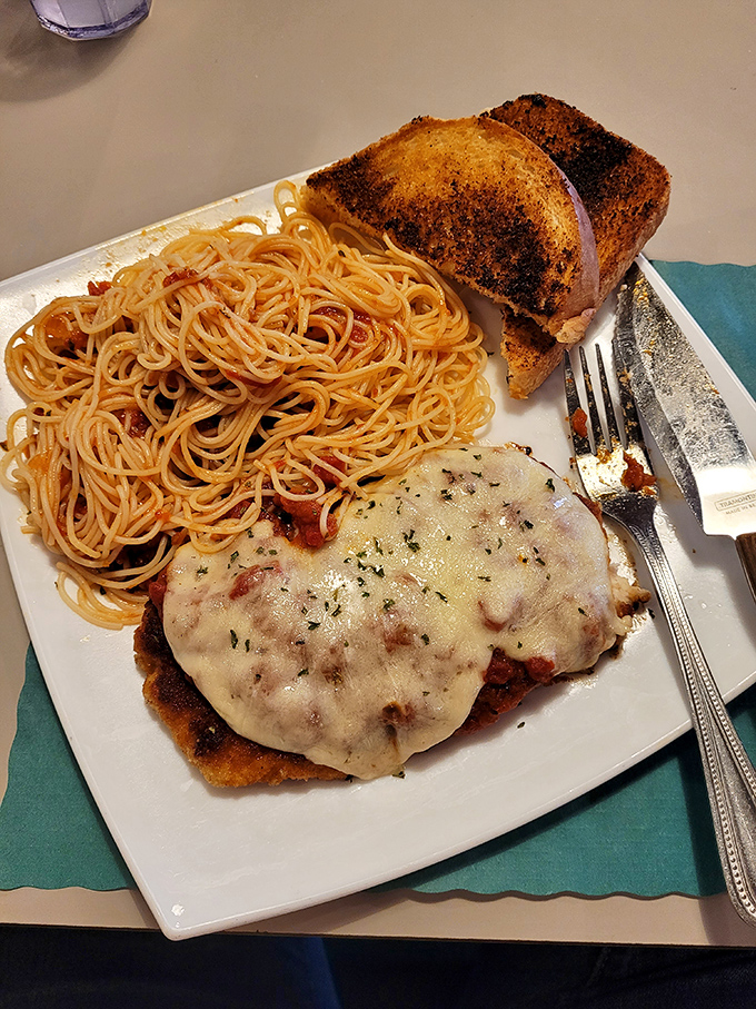 Chicken parmesan that would make an Italian grandmother nod in approval, paired with spaghetti that's clearly never seen the inside of a can.