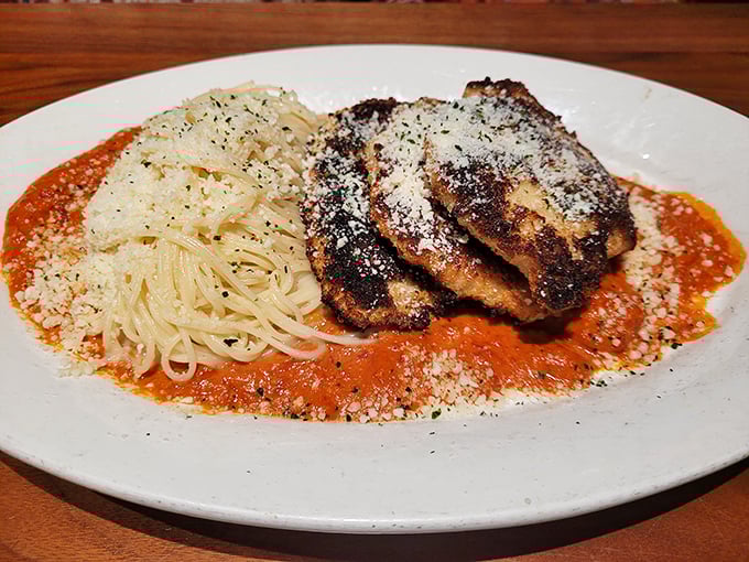 This isn't just chicken parmesan—it's a crispy, cheesy love letter to Italian-American cuisine that makes your grandmother's recipe nervously look over its shoulder.