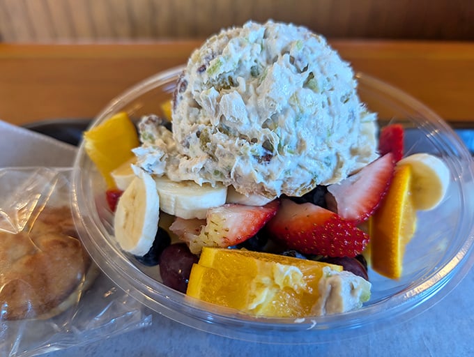 A fruit salad that doesn't apologize for being healthy, topped with a scoop that whispers, "Don't worry, we still understand dessert."