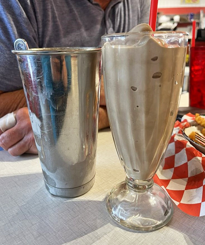 This chocolate malt isn't just thick—it's contemplating a career change to become a milkshake. The metal mixing cup is the gift that keeps on giving.