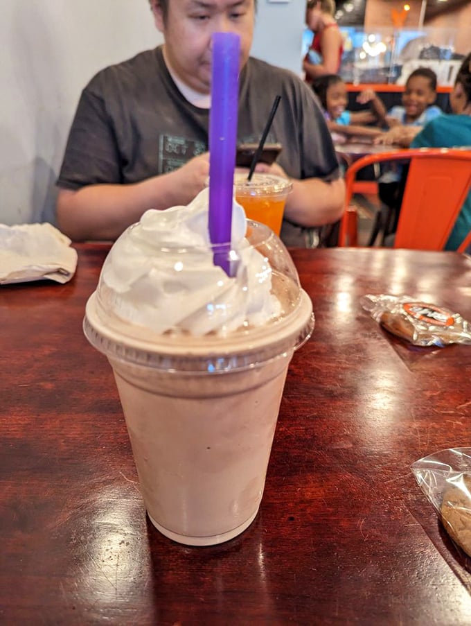 This isn't just a milkshake—it's dessert with a straw. The purple straw is your ticket to creamy bliss.