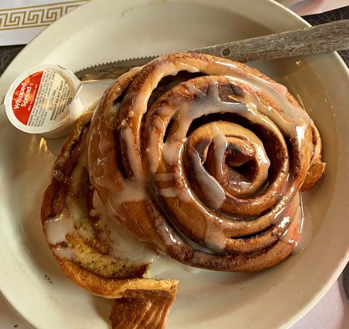 This isn't just a cinnamon roll – it's a spiral-shaped love letter to your taste buds, glazed with the kind of sweetness that makes Monday bearable.