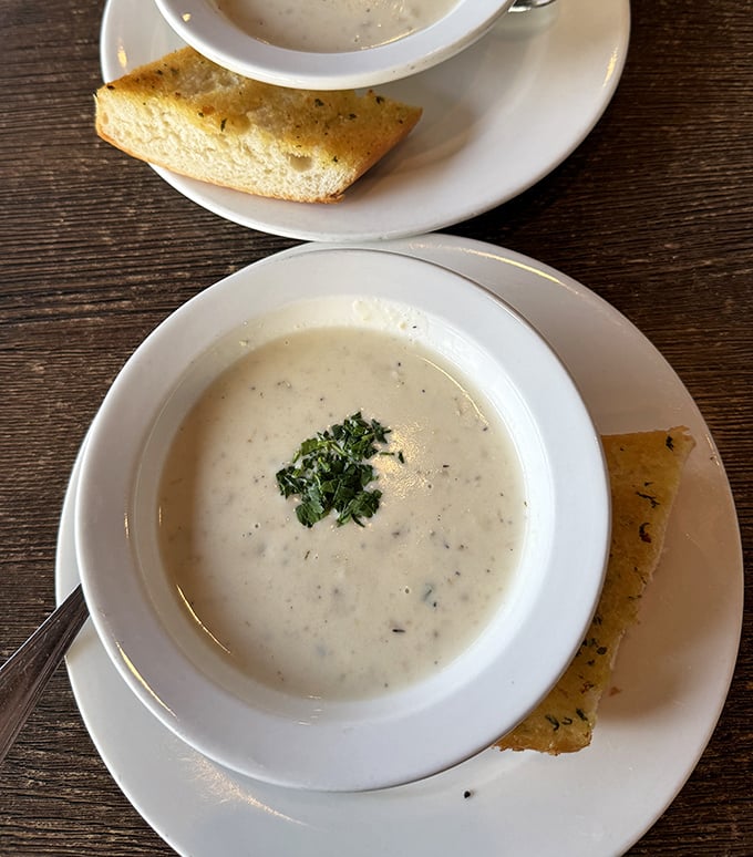 This isn't just clam chowder—it's a creamy bowl of ocean comfort, with herbs sprinkled like confetti celebrating the marriage of clams and potatoes.