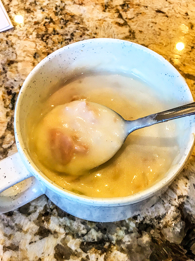 These plump dumplings floating in golden broth aren't just soup – they're little edible treasure chests waiting to be discovered.