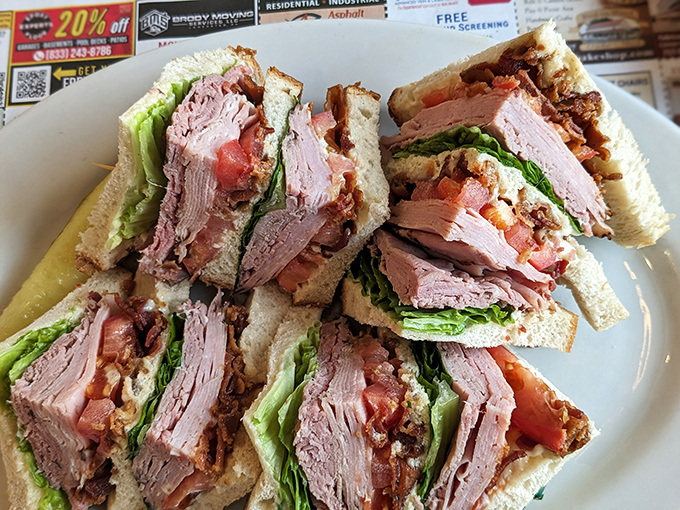 This club sandwich isn't just stacked—it's architectural. Layers of fresh turkey, crisp bacon, and garden vegetables create the skyscraper of sandwiches your lunch hour deserves. 