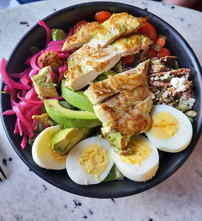 Not your average earthbound salad—grilled chicken, avocado, pickled onions, and hard-boiled eggs orbit fresh greens in perfect nutritional harmony.