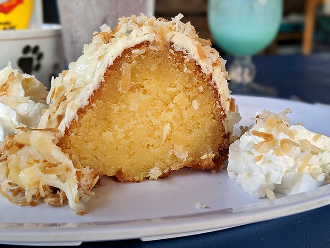 Coconut rum cake that would make pirates abandon their quests—moist, decadent, and topped with toasted coconut flakes that crunch with tropical abandon.