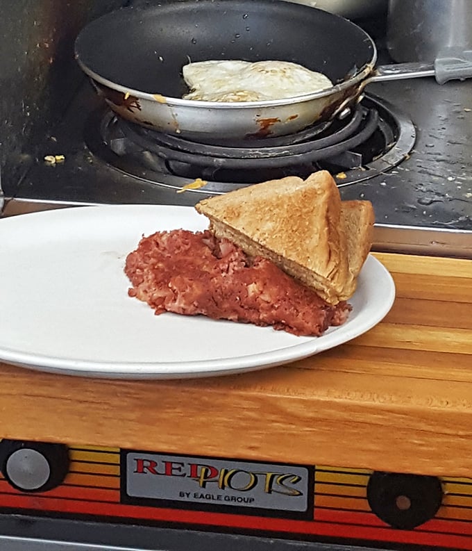 Corned beef hash that doesn't come from a can, paired with toast that's actually seen the business end of real butter.