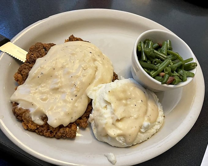 Country fried steak smothered in gravy with a side of green beans – proof that sometimes the most beautiful things in life aren't beautiful at all.