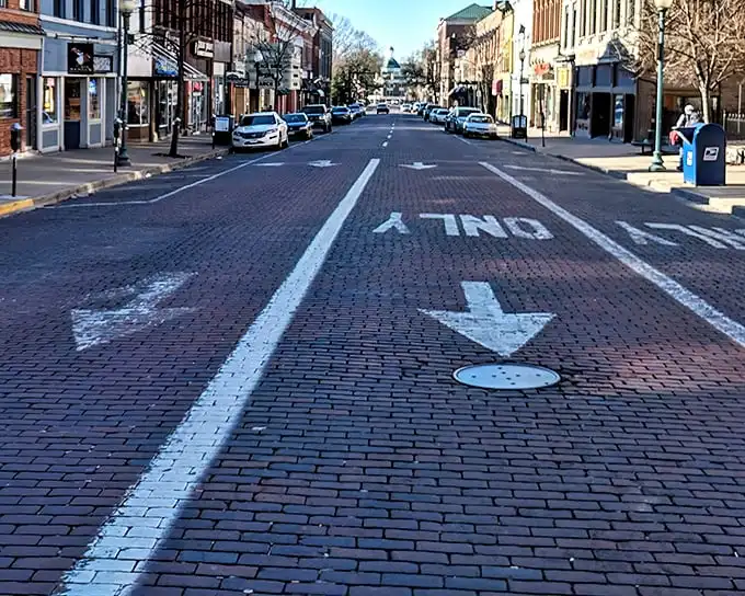Court Street's brick thoroughfare isn't just a road—it's Athens' red carpet, rolling out a welcome that's been perfected since the 19th century.