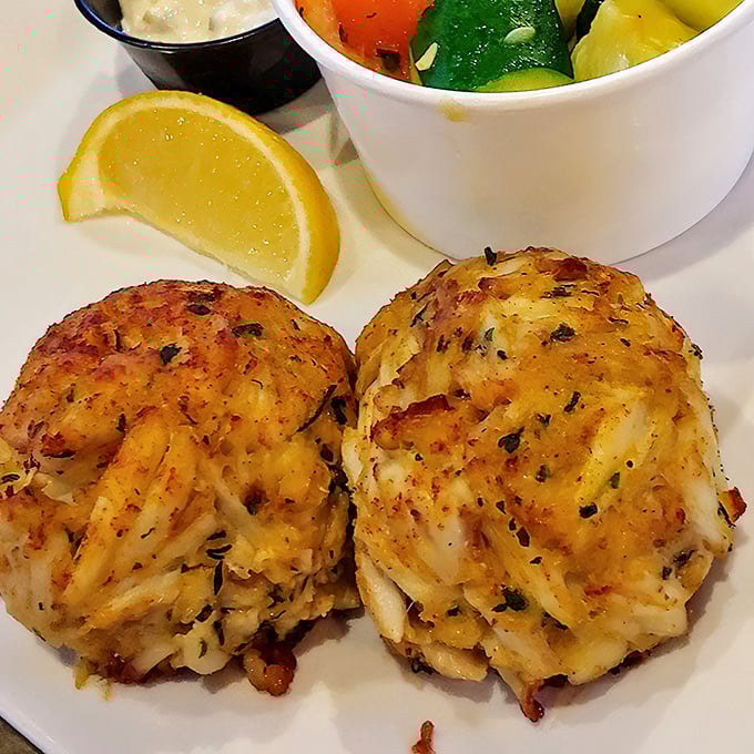 Maryland crab cakes done right—mostly crab, barely bound, golden-brown perfection that would make locals nod in approval.