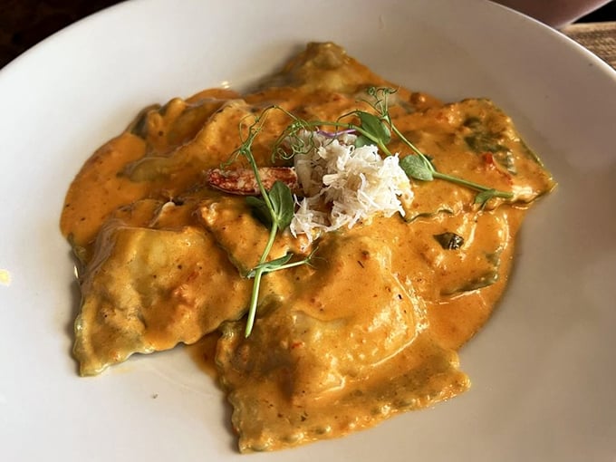 These ravioli aren't just stuffed, they're dressed for the seafood prom—crowned with crabmeat and bathed in a sauce that demands bread for sopping.
