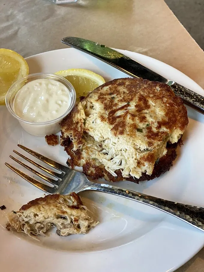 This golden-brown crab cake is what seafood dreams are made of—minimal filler, maximum crab, and a side of tangy sauce for dipping.