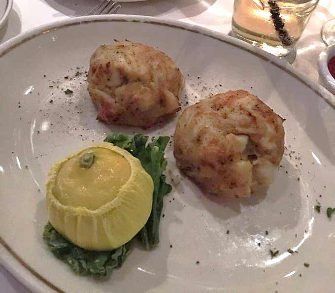 These aren't just crab cakes; they're seafood sculptures—golden-brown on the outside, delicately sweet and flaky within. The lemon stands ready for its supporting role.