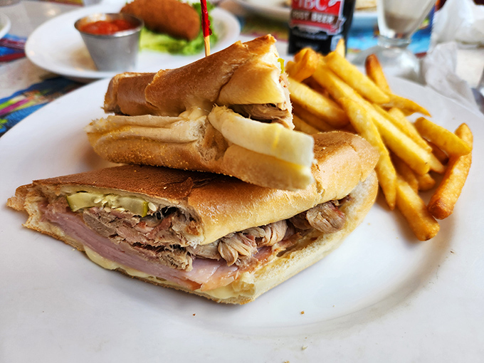 The Cuban sandwich arrives like a diplomatic mission between bread nations – ham, pork, and pickles negotiating perfect harmony on your plate.