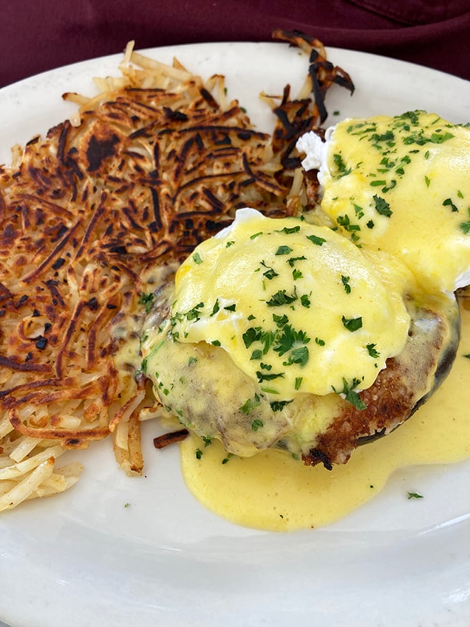 Eggs Benedict with a side of crispy hash browns—proof that perfection doesn't need reinvention, just consistent execution.
