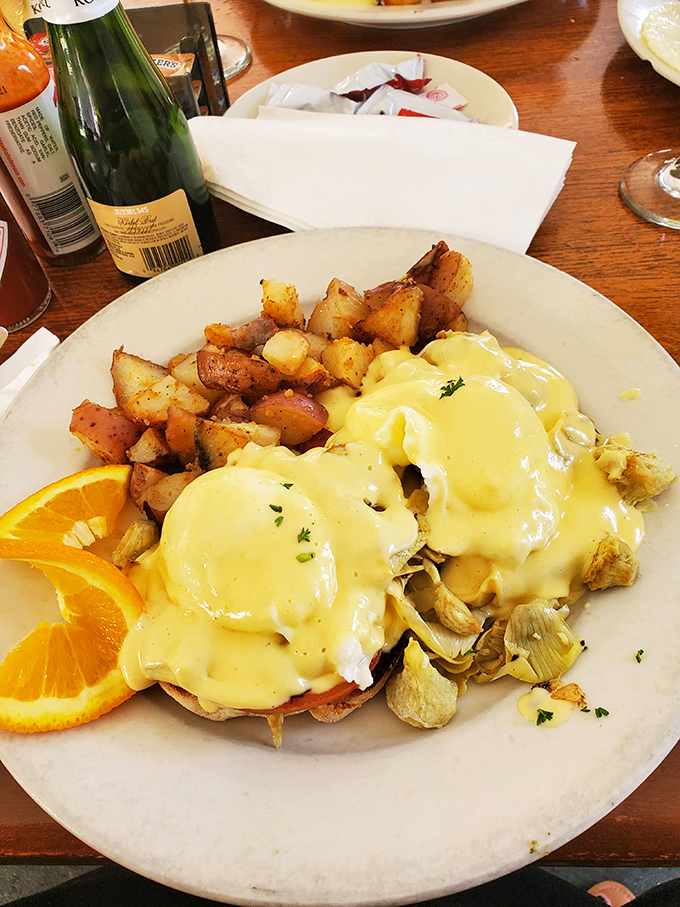 Eggs Benedict that would make a French chef tip his toque—golden hollandaise cascading over English muffins like a breakfast waterfall.