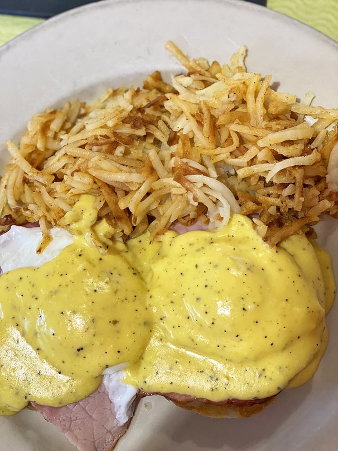 Those shredded hash browns look like they've achieved the holy grail—crispy exterior, tender interior—while that hollandaise sauce practically glows with promise.