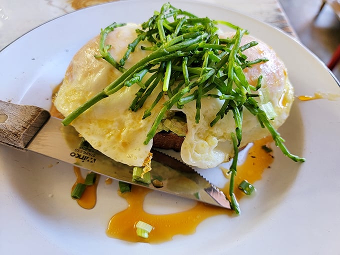 This isn't just eggs benedict—it's a morning masterpiece. Perfectly poached eggs crowned with fresh greens and hollandaise that flows like liquid sunshine.
