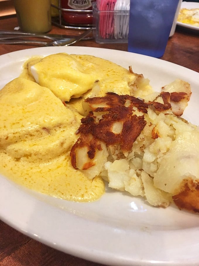Eggs Benedict done right—crispy hash browns with that essential griddle char meet hollandaise so sunny it rivals the Arizona morning sky.
