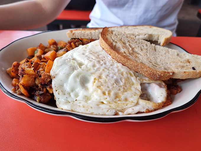 Breakfast alchemy at its finest—crispy potatoes, farm-fresh eggs, and toast that actually tastes like something. Morning salvation on a plate.