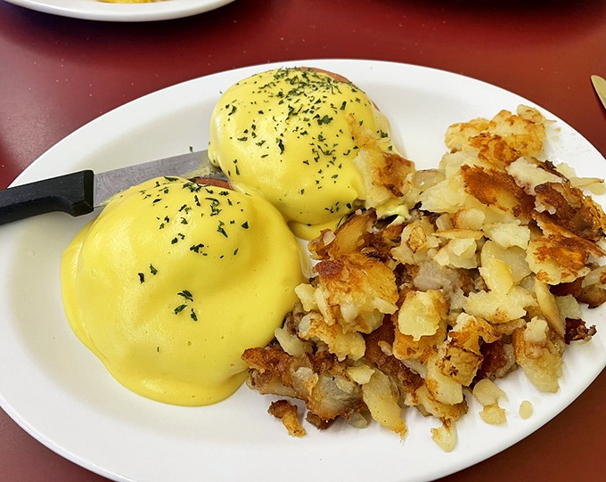 Eggs Benedict done right – when hollandaise flows like liquid gold over perfectly poached eggs.