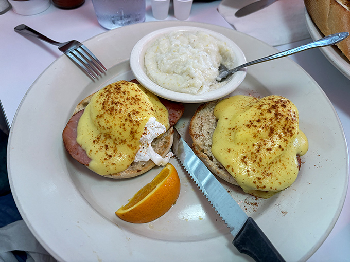 Eggs Benedict done right—perfectly poached eggs nestled on Canadian bacon, draped in hollandaise that's rich enough to need its own tax bracket.