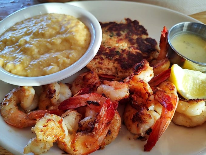 Perfectly grilled shrimp nestled beside grits that would make your grandmother both jealous and proud. The lemon wedge isn't optional – it's essential.