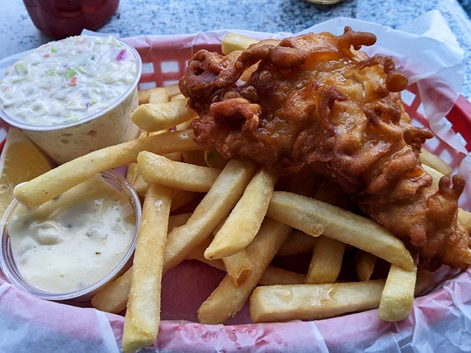 Golden-battered fish nestled on a bed of crispy fries—comfort food that whispers "vacation" even if you're just on your lunch break.