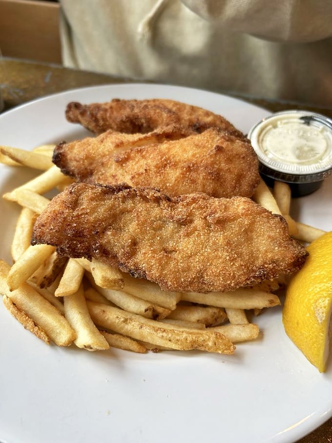 Golden-battered fish and chips that would make a British pub owner weep with envy – crispy perfection meets Pacific freshness.