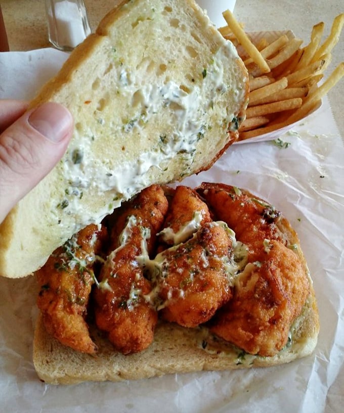 This isn't just fried fish on bread; it's a masterclass in seafood simplicity—crispy, golden fillets with tartar sauce that demands to be savored.
