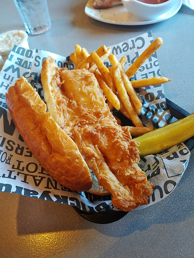 This fish sandwich isn't just swimming in flavor—it's doing the backstroke in a pool of golden, crispy perfection.
