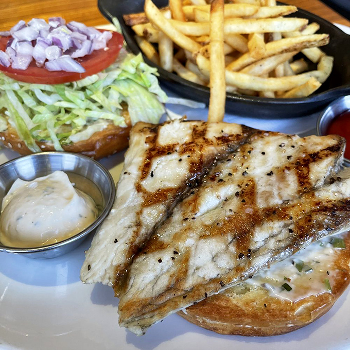 Grill marks on fish should be like a good marriage—distinct, purposeful, and something to admire. This sandwich delivers that commitment alongside crispy fries and house-made aioli.
