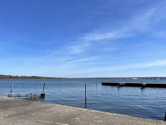 Peaceful waters mirror the sky while boats rest like sleeping giants in this protected maritime sanctuary.