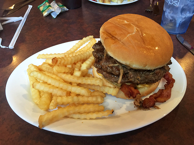 This isn't just a burger—it's an architectural masterpiece of beef, bacon, and cheese that requires both hands and absolutely zero shame.