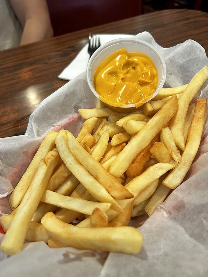 Golden fries with cheese sauce—a simple pleasure that requires no explanation, just appreciation. Crisp exterior, fluffy interior—the Aristotelian ideal of french fries.